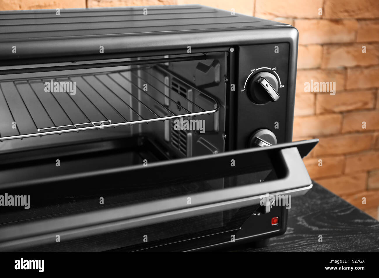 Modern electric oven on dark table, closeup Stock Photo - Alamy
