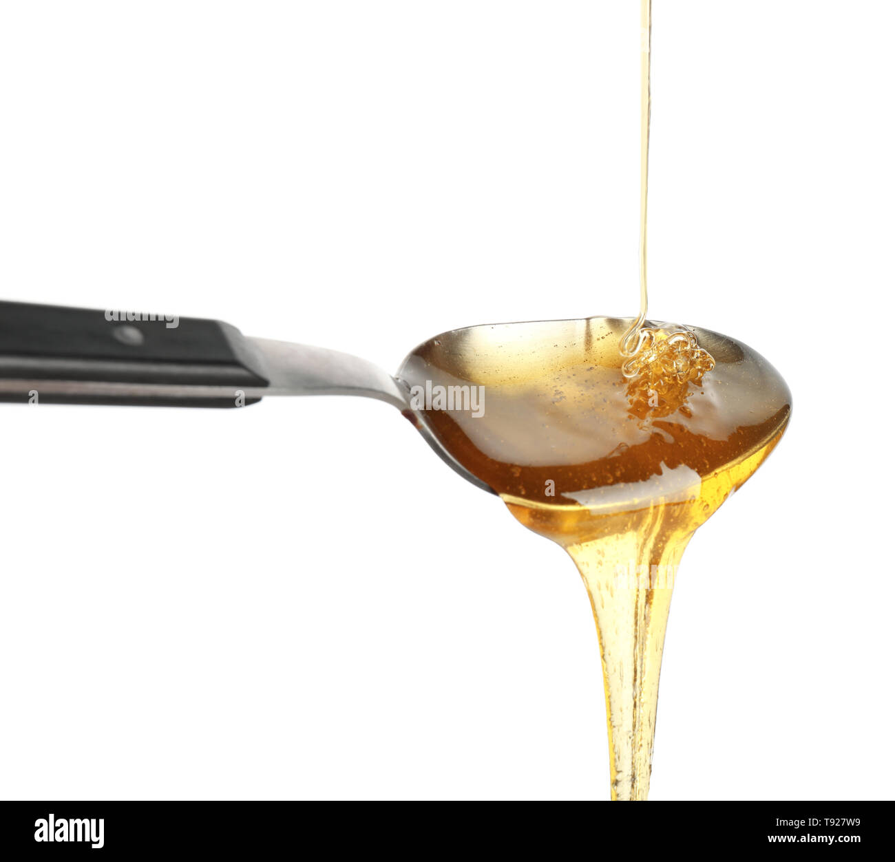 Metal Spoon With Honey Against White Background Stock Photo Alamy