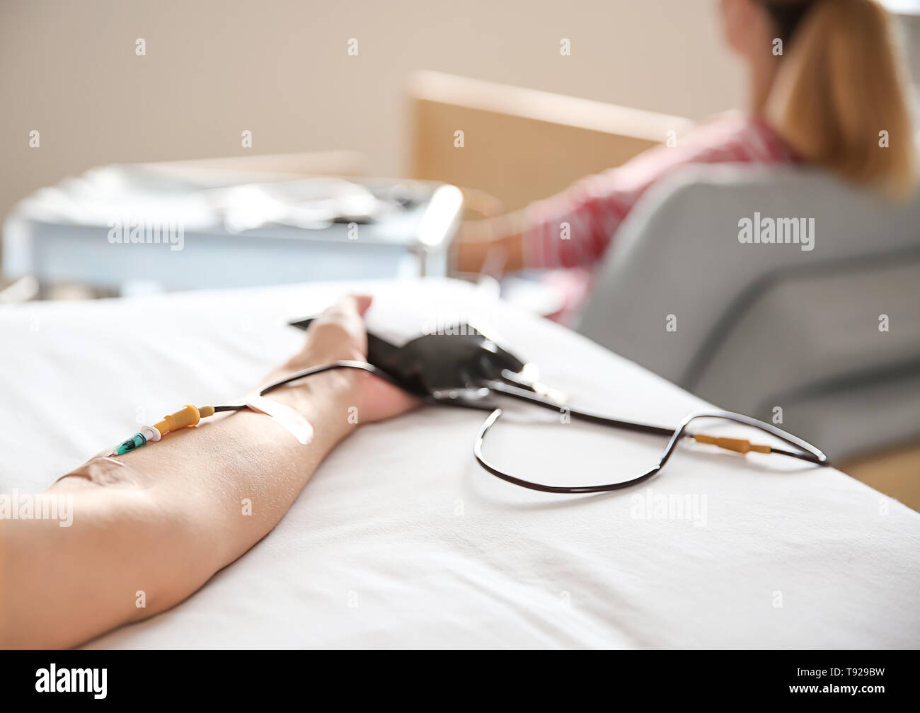 Woman donating blood in hospital Stock Photo - Alamy