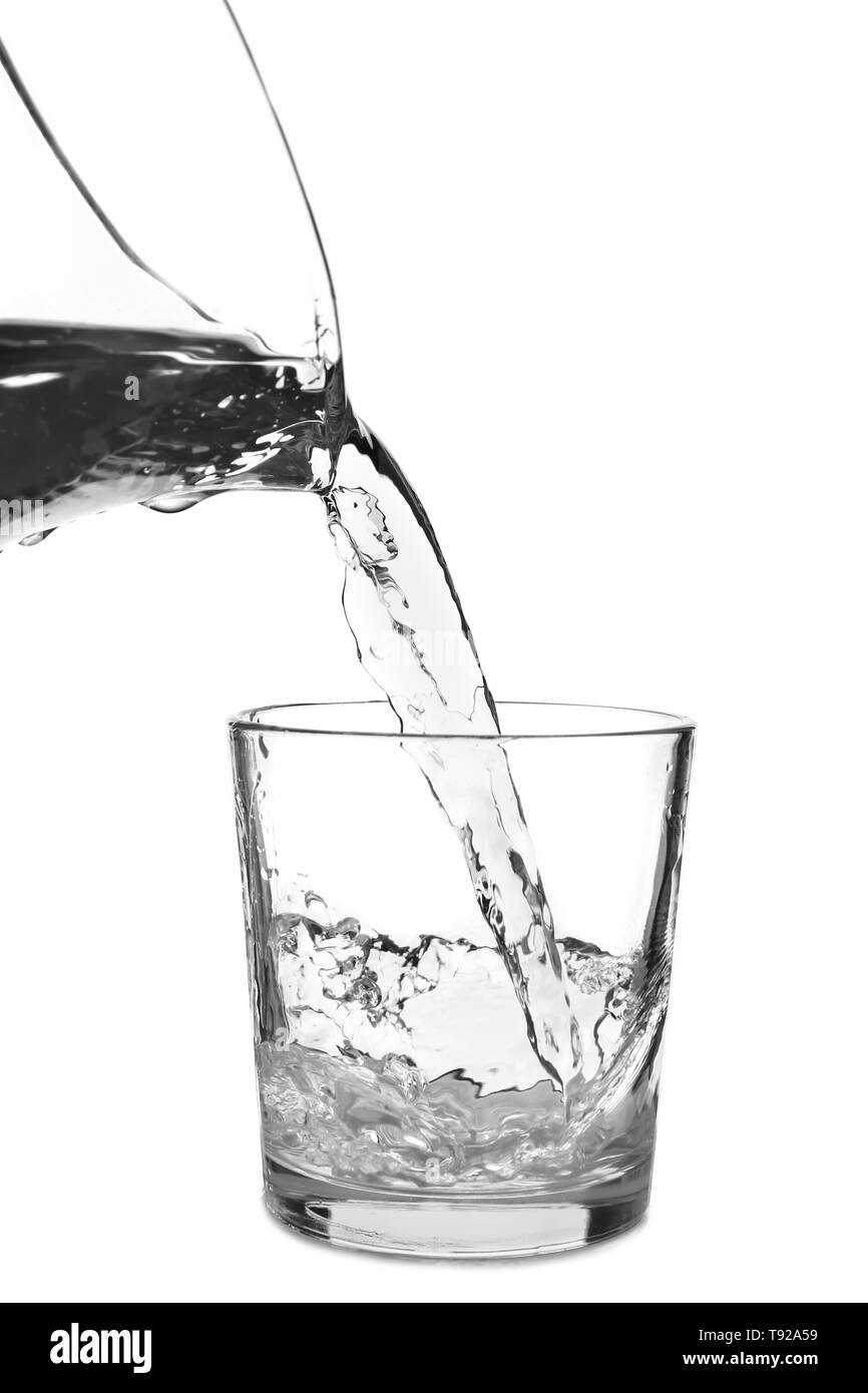 Pouring of water in glass on white background Stock Photo - Alamy