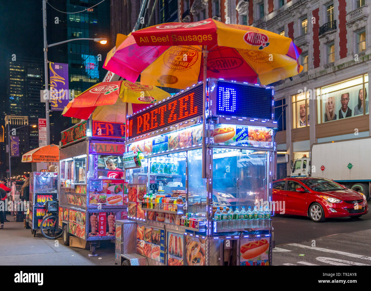 Street food in New York, mobile food carts lined up on the sidewalk at ...