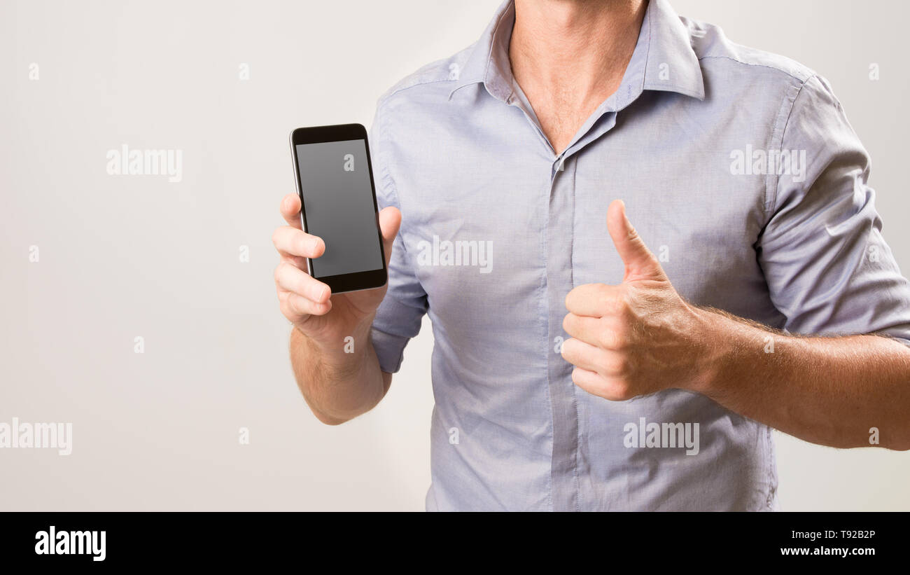 Man holding cell phone as if he is showing you something and giving the ...
