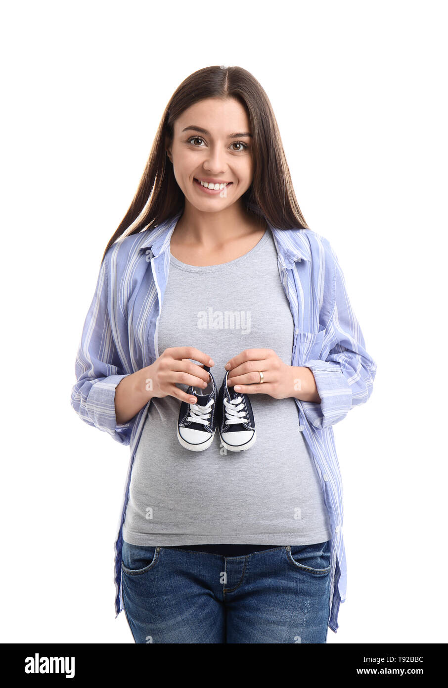 Beautiful pregnant woman with baby boots on white background Stock ...