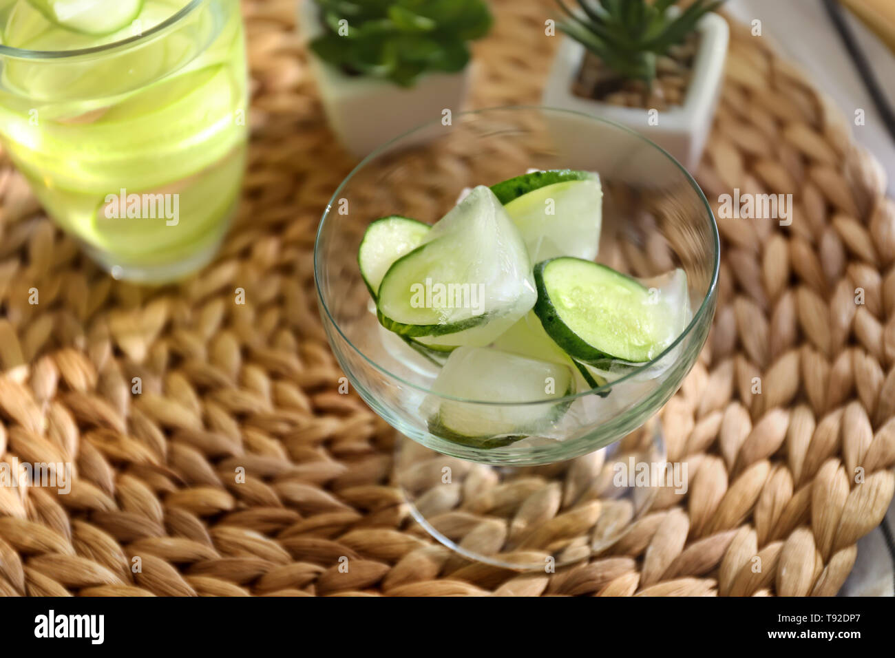 Glass bowl with frozen cucumber slices on wicker mat Stock Photo - Alamy