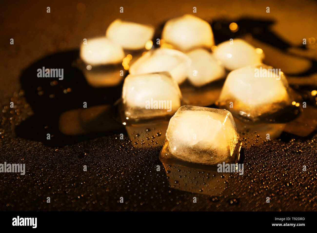 Ice cubes on surface with drops Stock Photo - Alamy