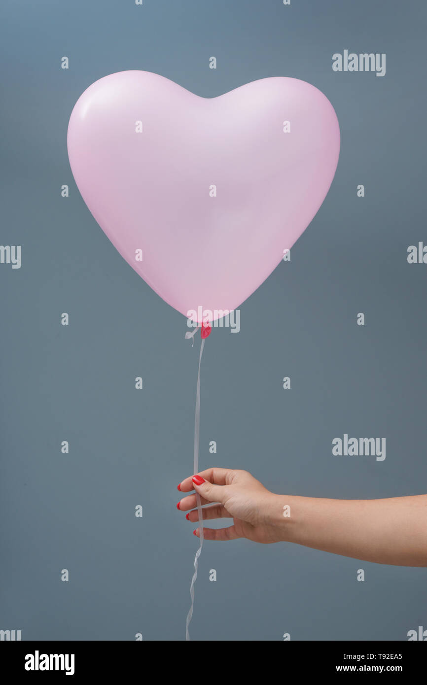 Woman hand holding heart as a symbol of love Stock Photo - Alamy