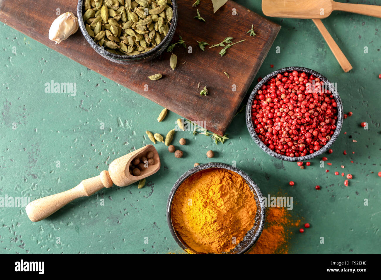 Bowls with different aromatic spices on color table Stock Photo - Alamy
