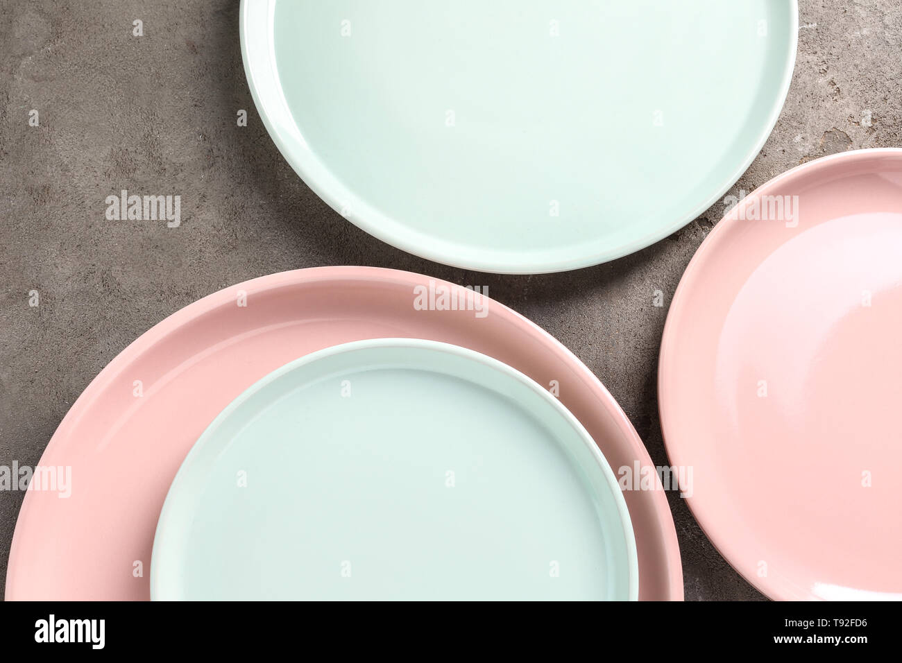 Set of clean color plates on table Stock Photo - Alamy