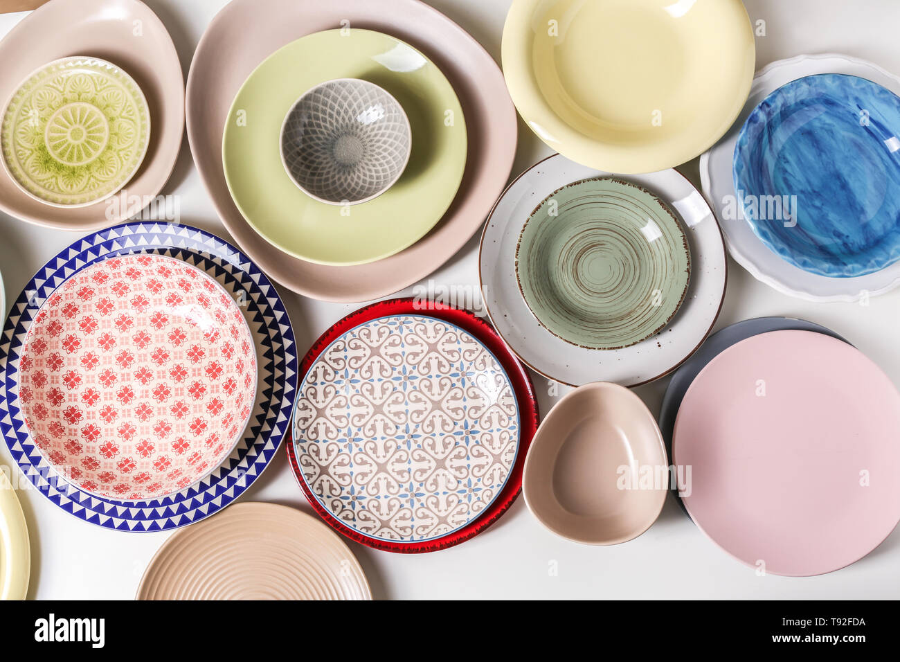 Set of clean color plates on table Stock Photo - Alamy