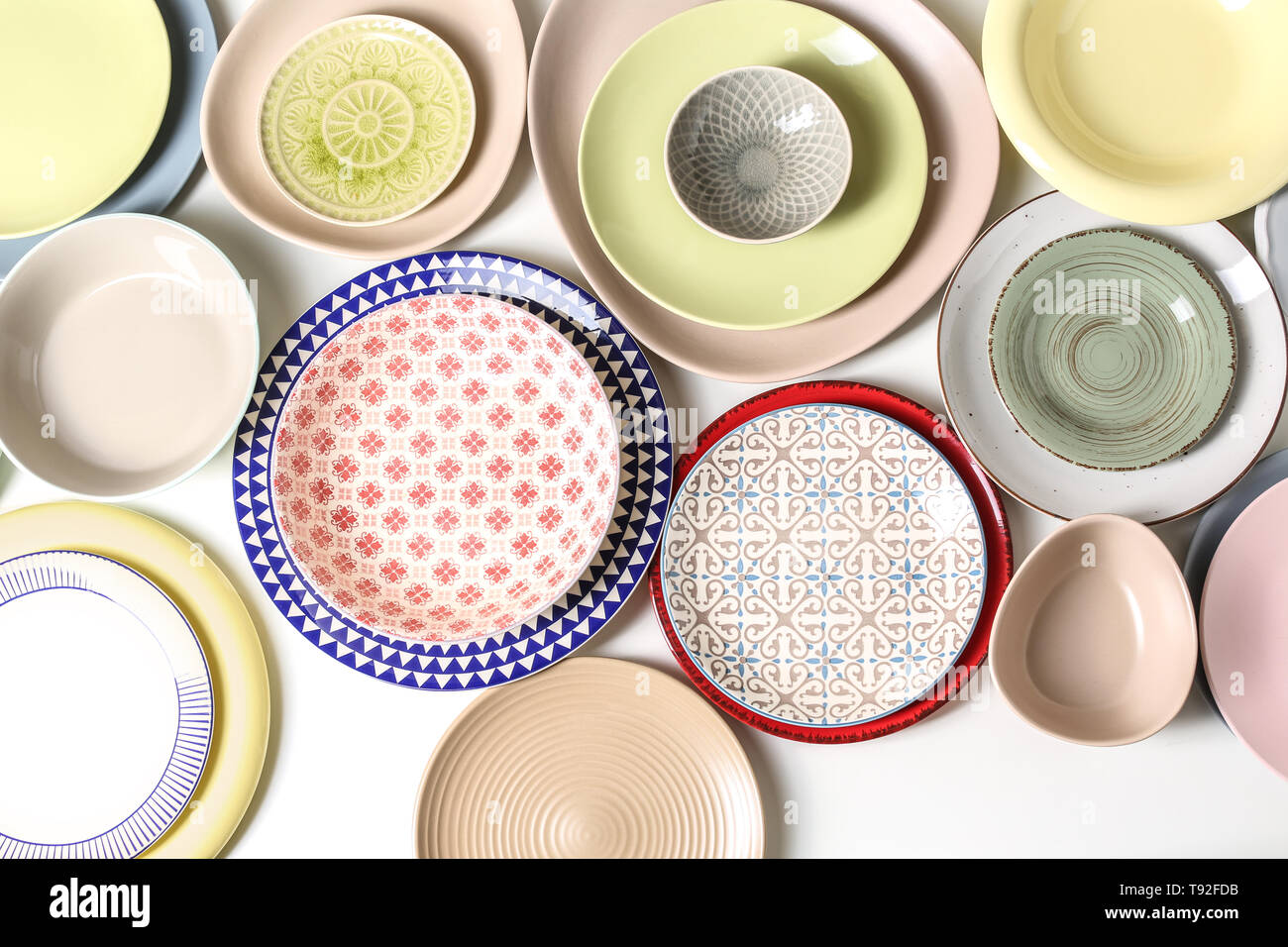 Set of clean color plates on table Stock Photo - Alamy