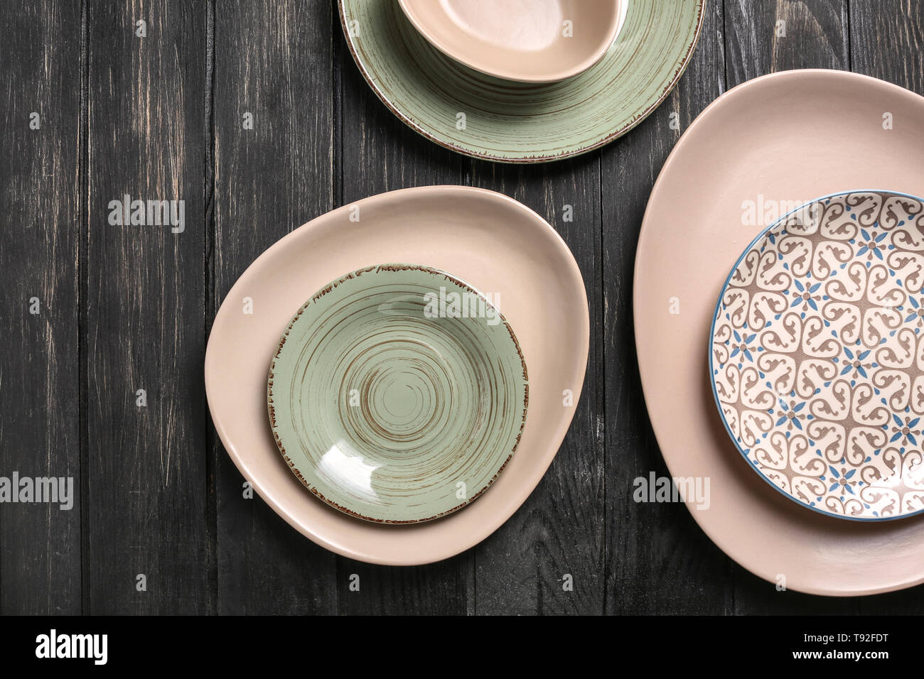 Set of clean color plates on table Stock Photo - Alamy
