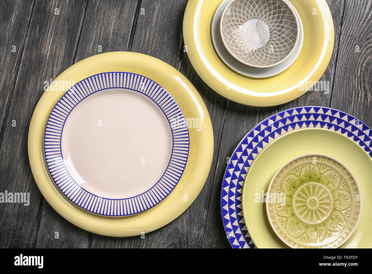 Set of clean color plates on table Stock Photo - Alamy