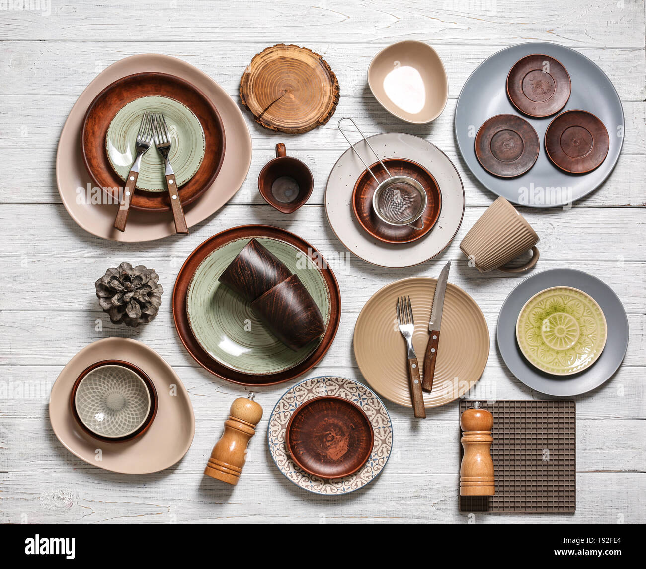 Different tableware and cutlery on wooden table Stock Photo - Alamy