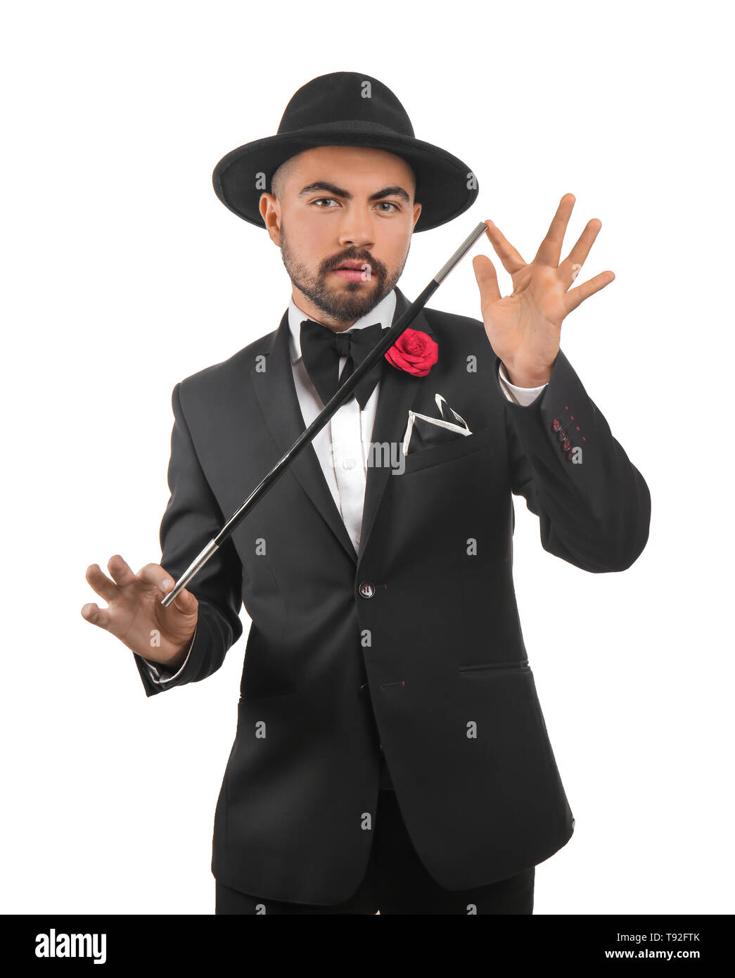 Male magician showing tricks on white background Stock Photo - Alamy