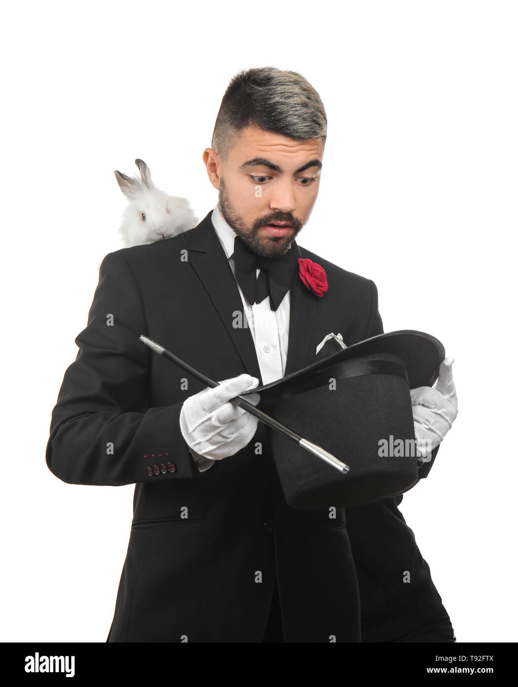 Male magician showing tricks on white background Stock Photo - Alamy