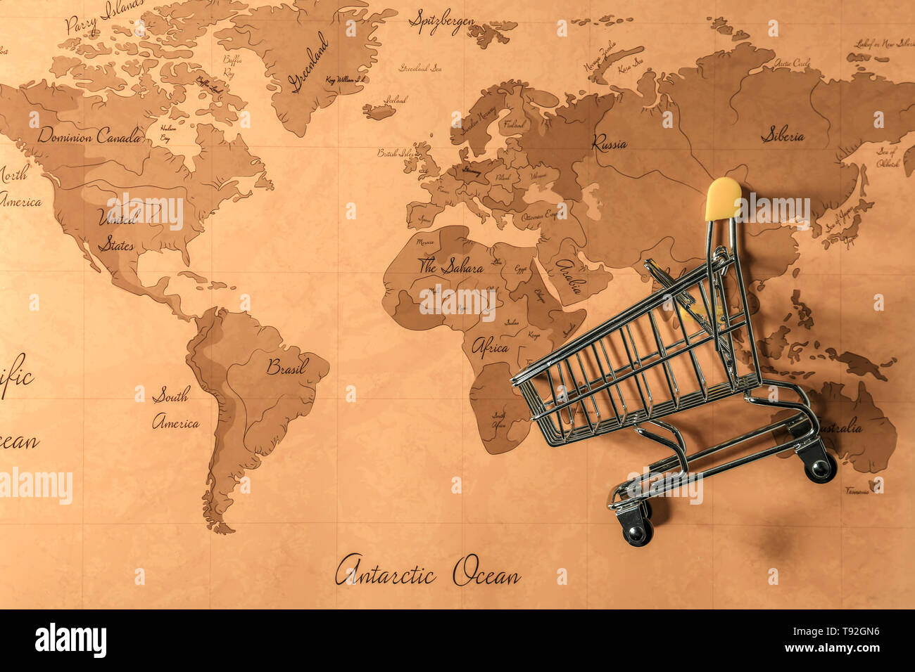Small shopping cart on vintage world map Stock Photo - Alamy