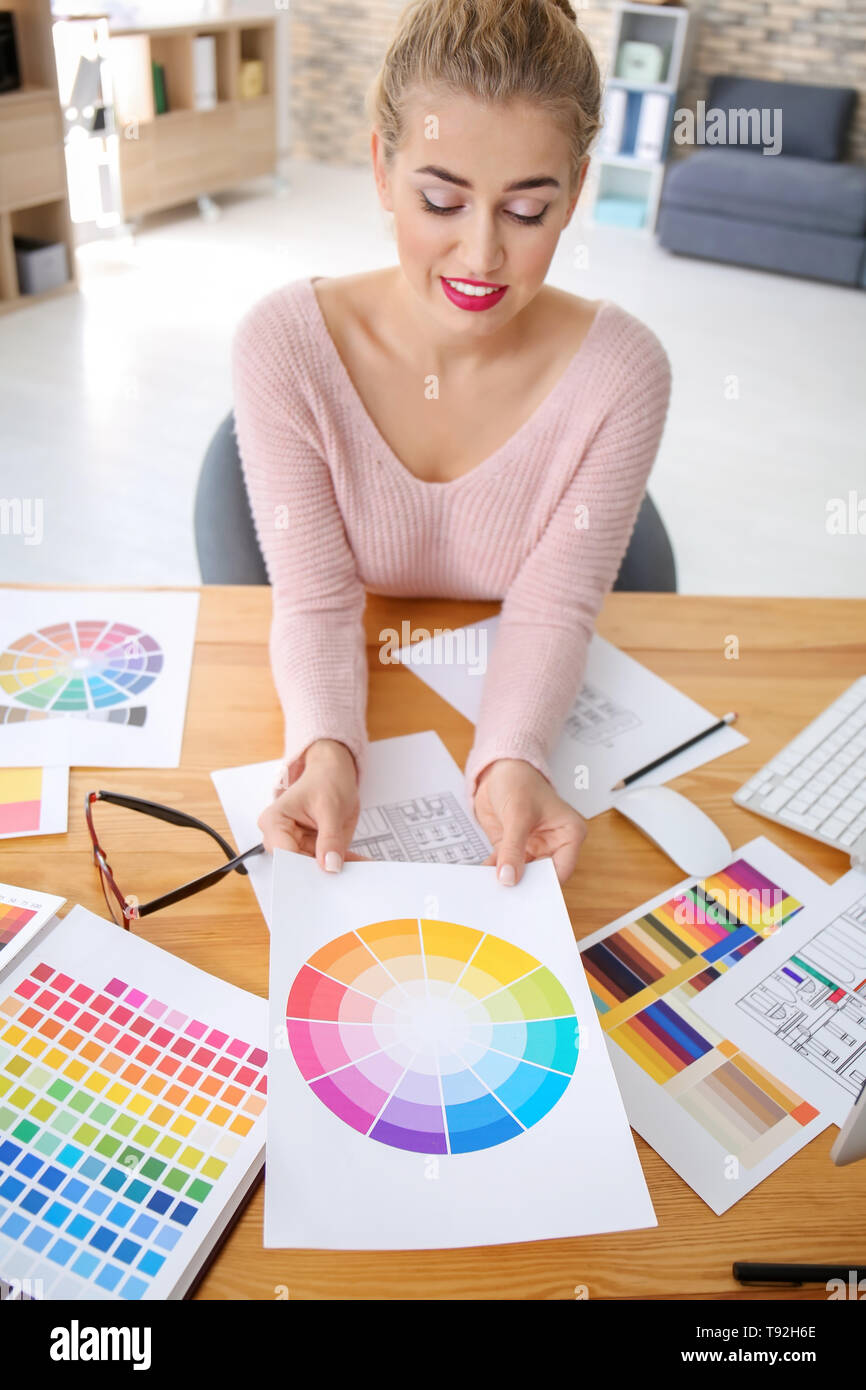 Beautiful young designer working with color palette in office Stock ...