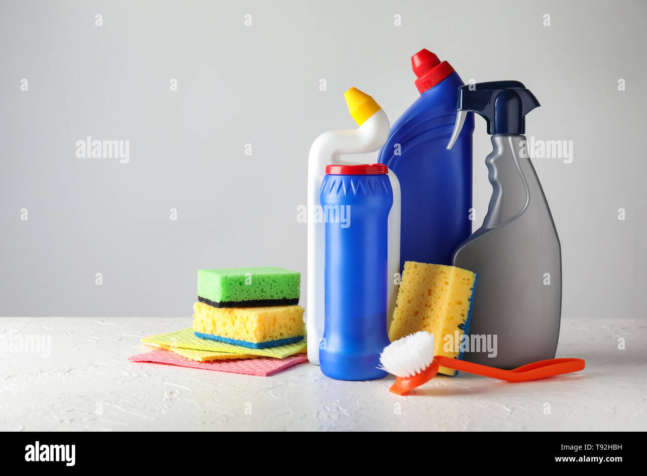 Set of cleaning supplies on table Stock Photo - Alamy