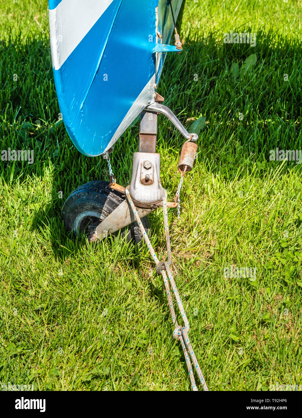 Rear view of tail rudder and wheel of a vintage single engine aircraft ...