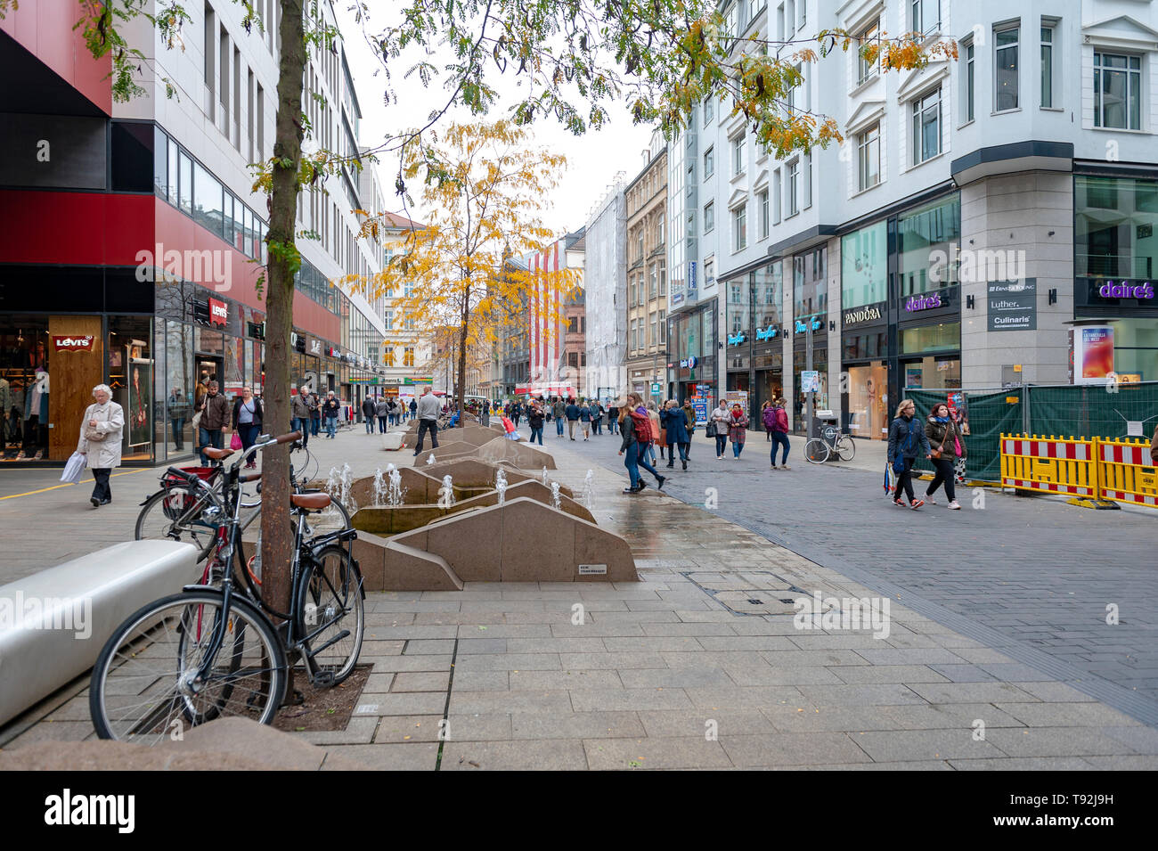 Pedestrians on street alongside with old buildings in central business ...
