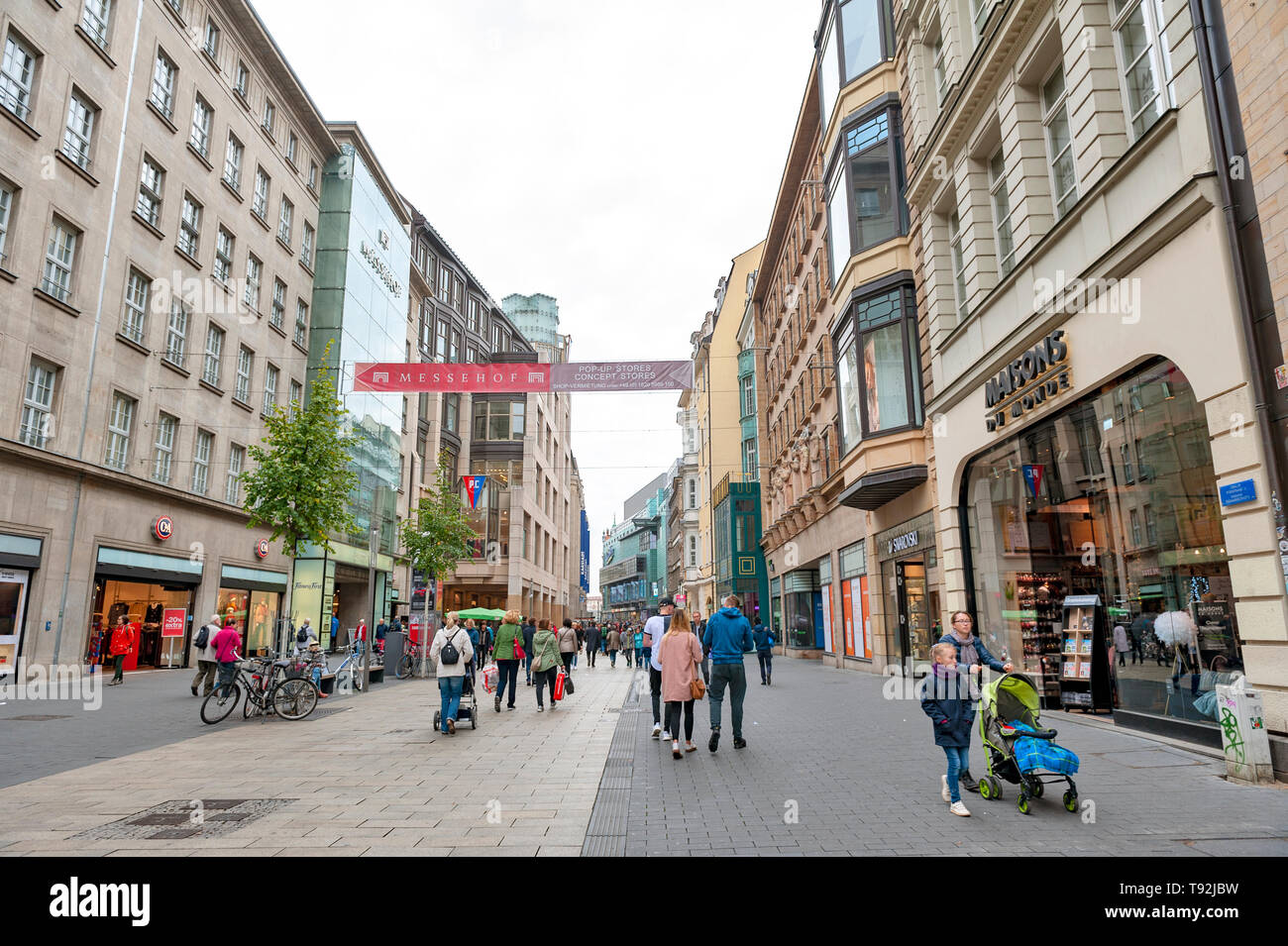 Pedestrians on street alongside with old buildings in central business ...