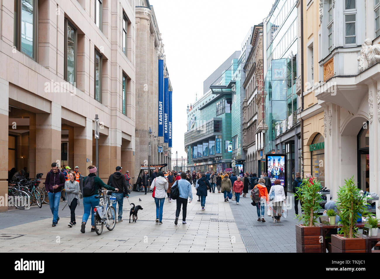 Pedestrians on street alongside with old buildings in central business ...
