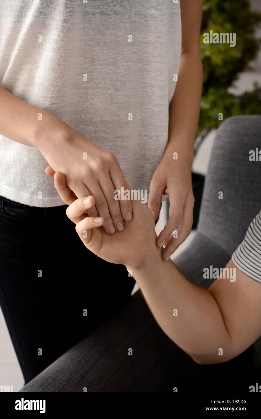 Young couple holding hands at home Stock Photo - Alamy