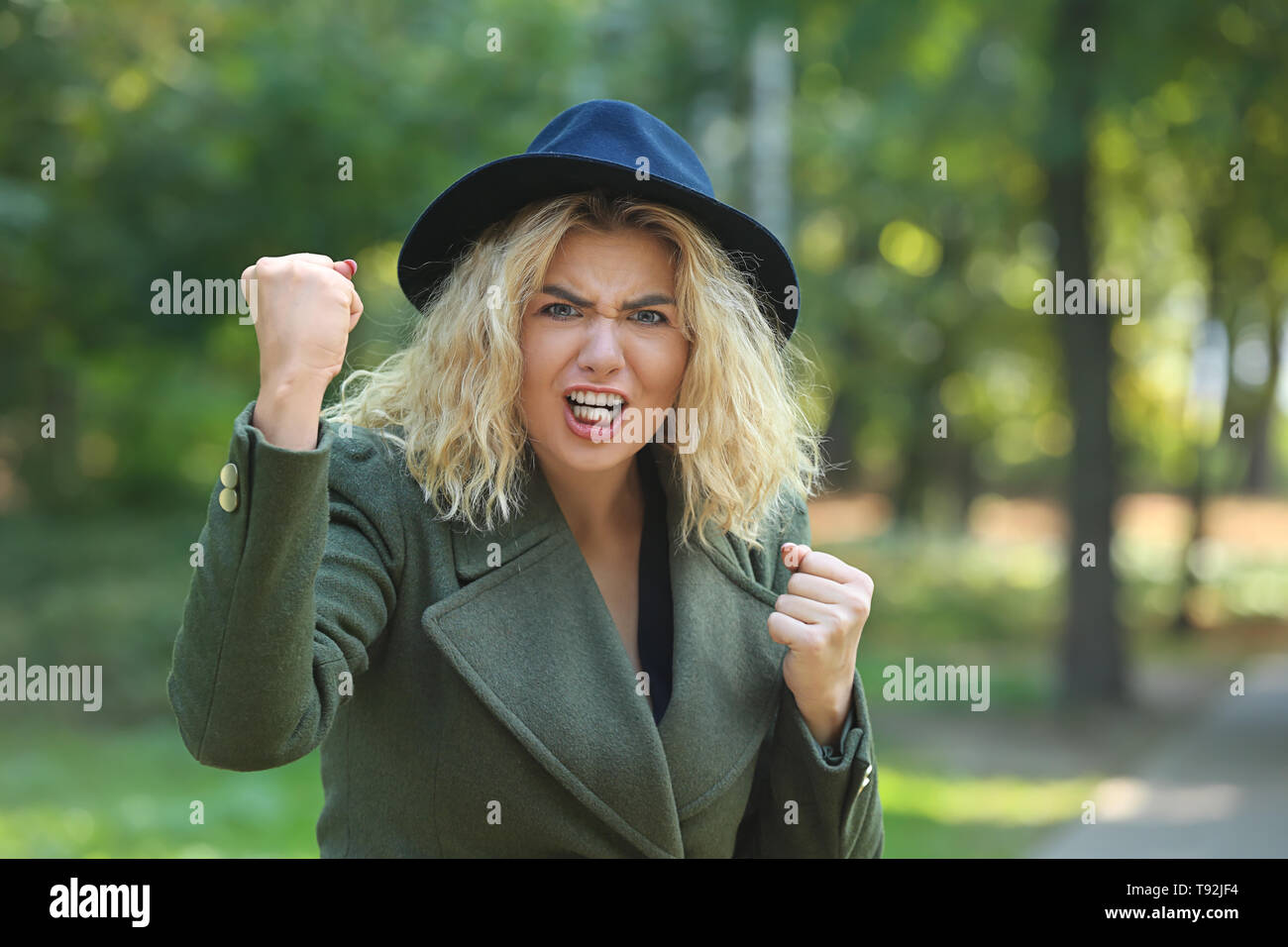 Angry young woman outdoors Stock Photo - Alamy