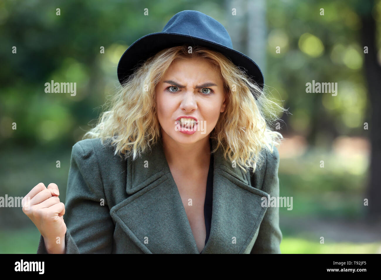 Angry young woman outdoors Stock Photo - Alamy