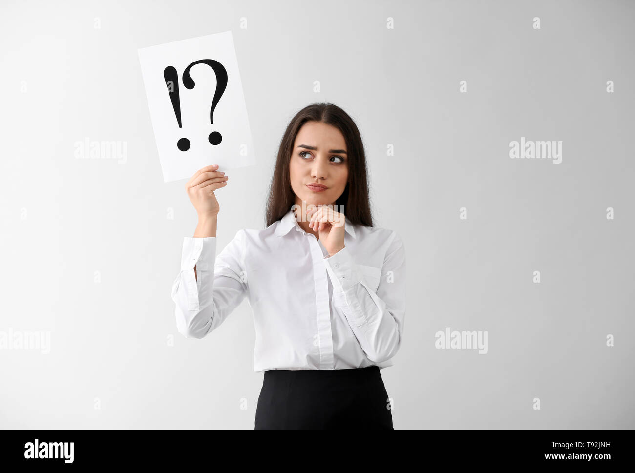 Emotional woman holding sheet of paper with exclamation and ...