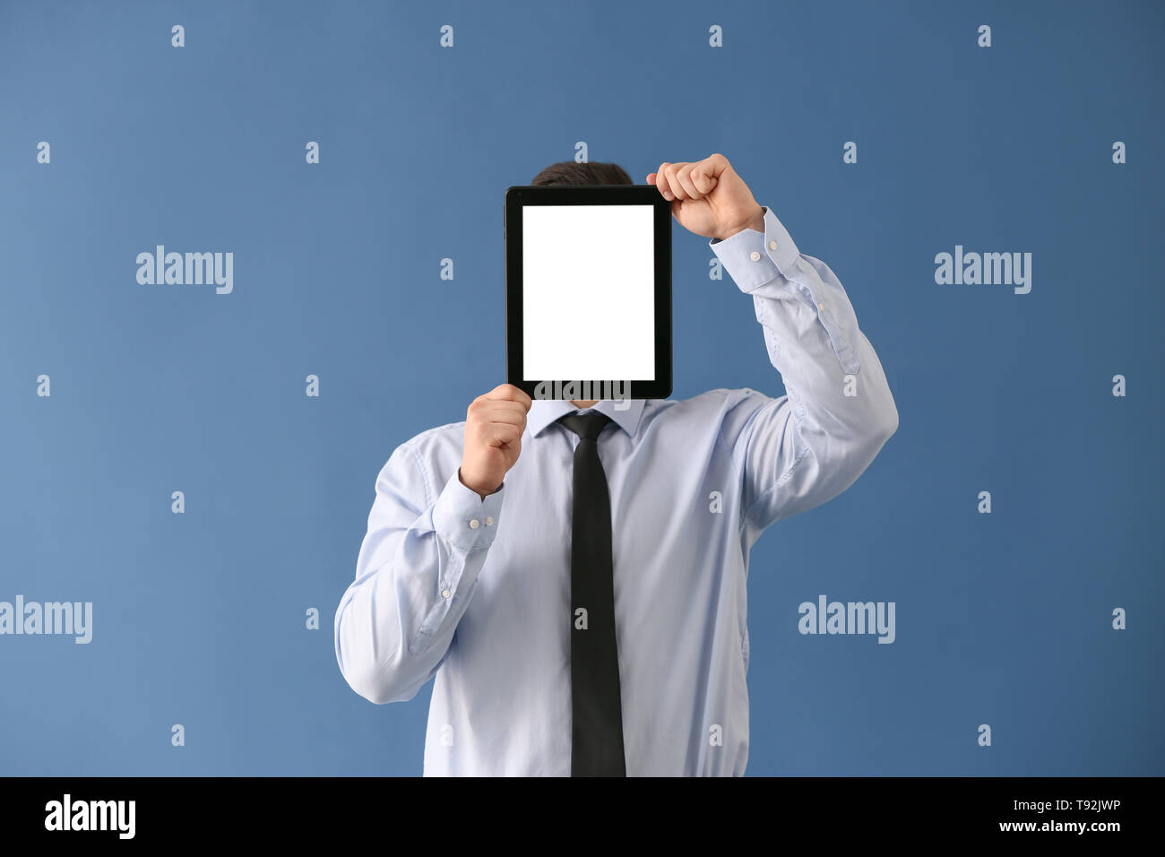Man with tablet covering face hi-res stock photography and images - Alamy