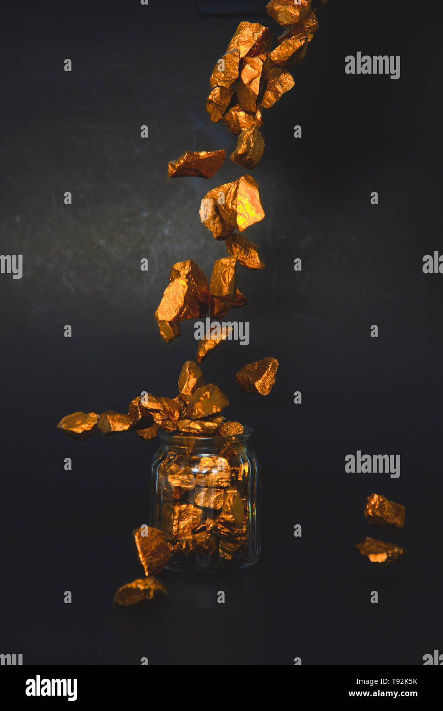 Falling gold nuggets, gold ore , precious stone or lump of golden stone ...