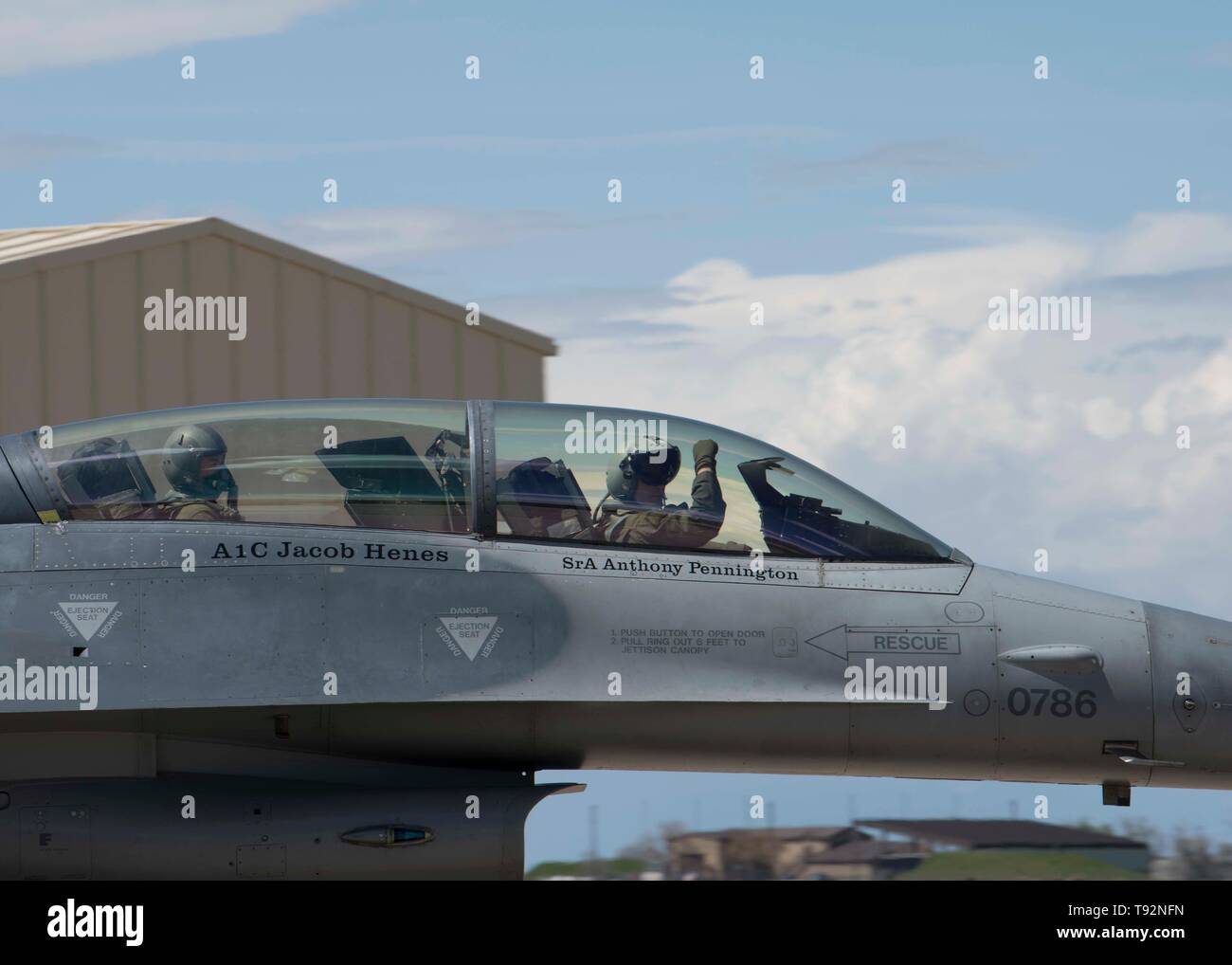 A 311th Fighter Squadron F-16 Fighting Falcon pilot displays the ...