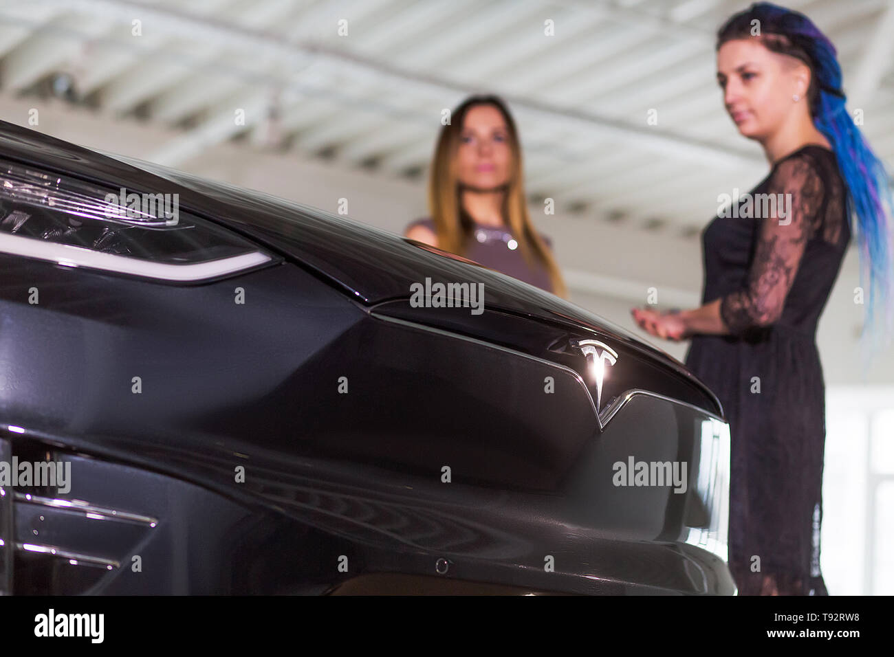 Girl is Buying Expensive Tesla Electromobile in Auto Show Stock Photo ...