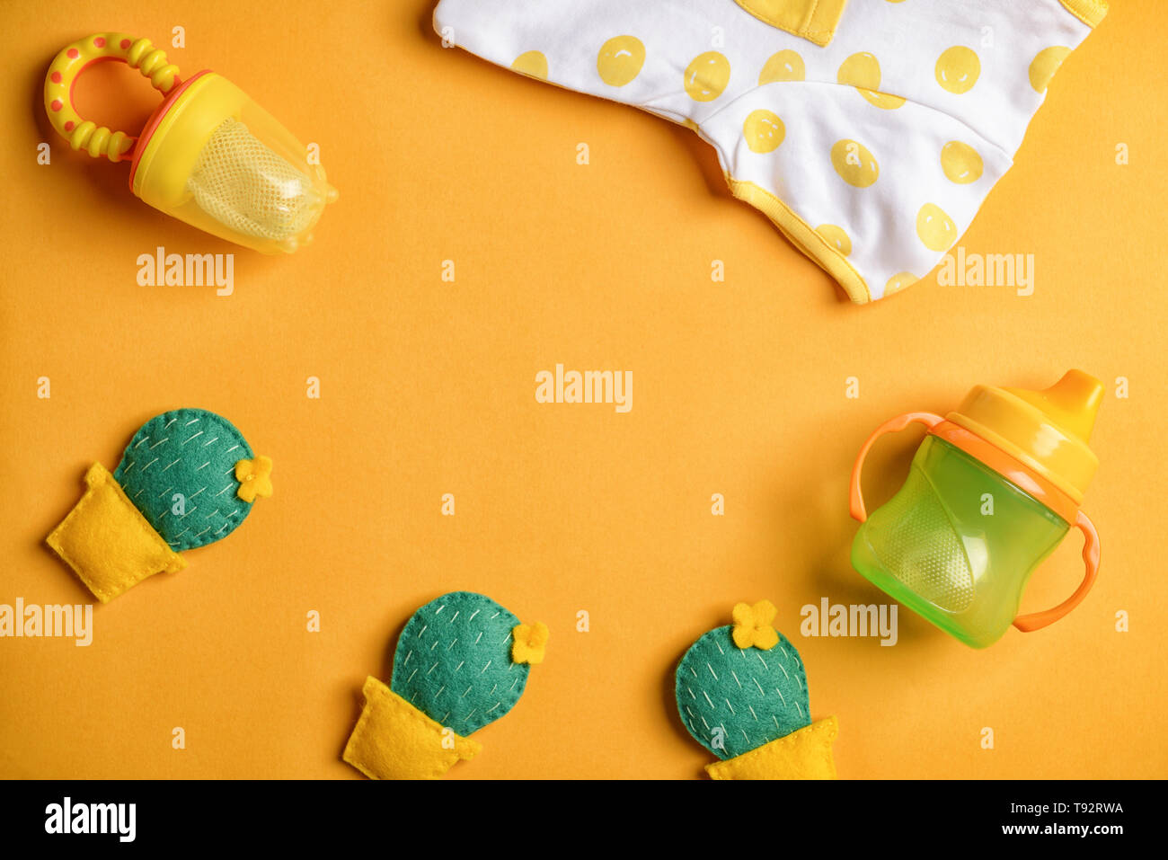 Frame made of baby clothes and accessories on color background, flat ...