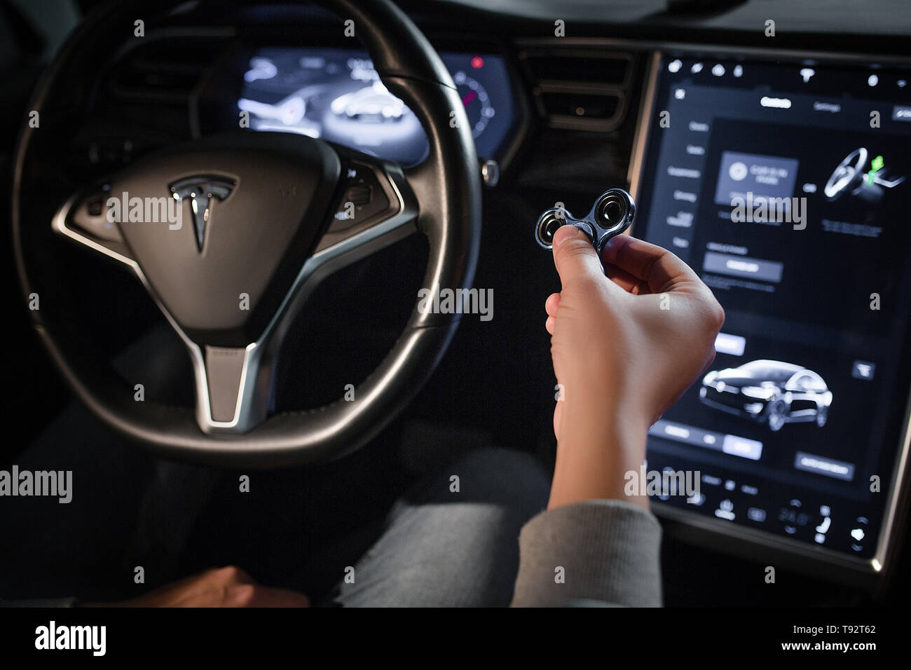 Inside view of Tesla Electric Vehicle. Sreering Wheel and Displays ...