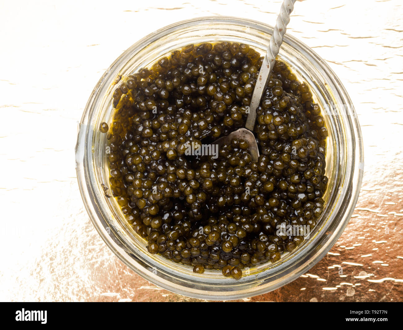 Black caviar, luxurious delicacy on golden background, protein rich ...