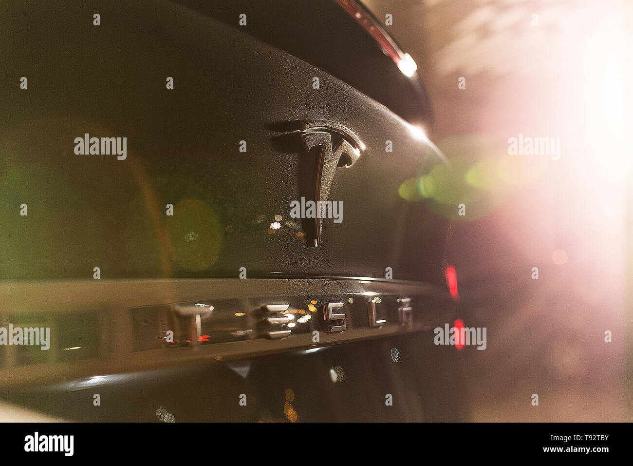 Tesla Emblem on Black Car. Close-Up Silver Logo Stock Photo - Alamy