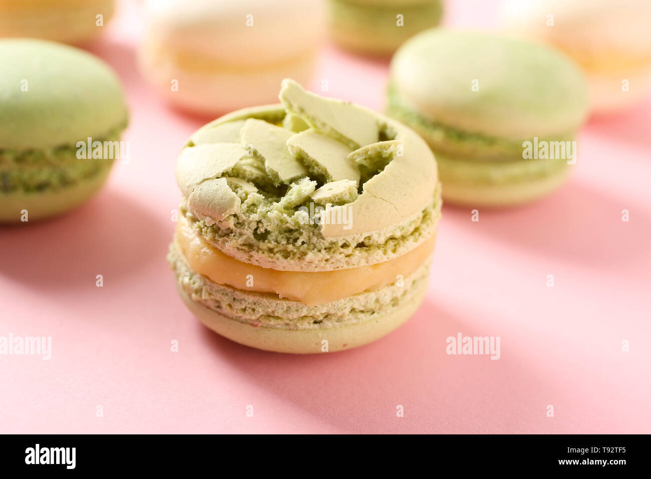 Sweet crushed macaroon on color background Stock Photo - Alamy