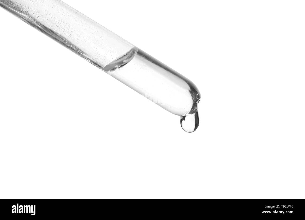 Pipette with dripping liquid on white background Stock Photo - Alamy