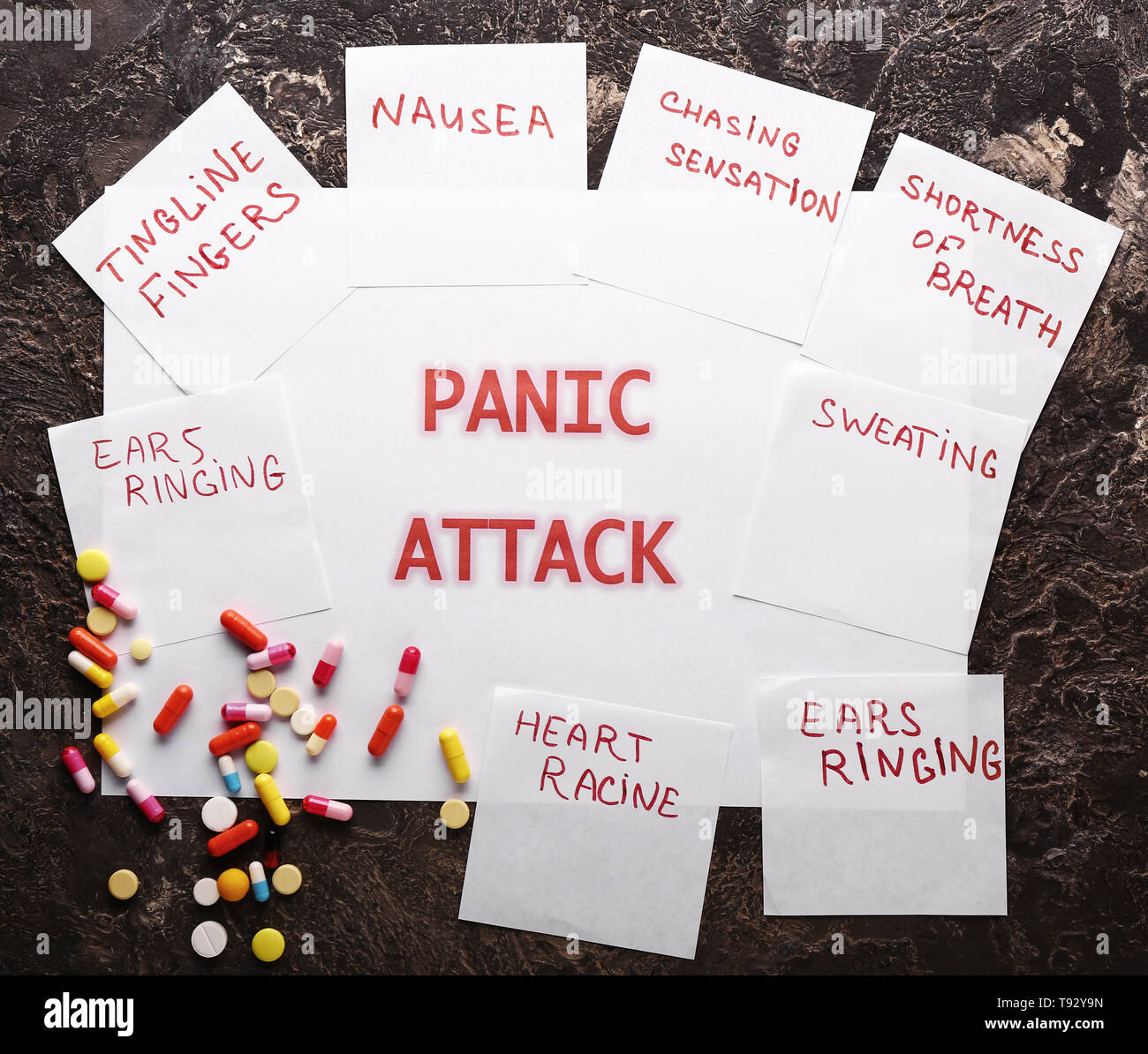 Paper cards with text PANIC ATTACK and symptoms on grey background ...