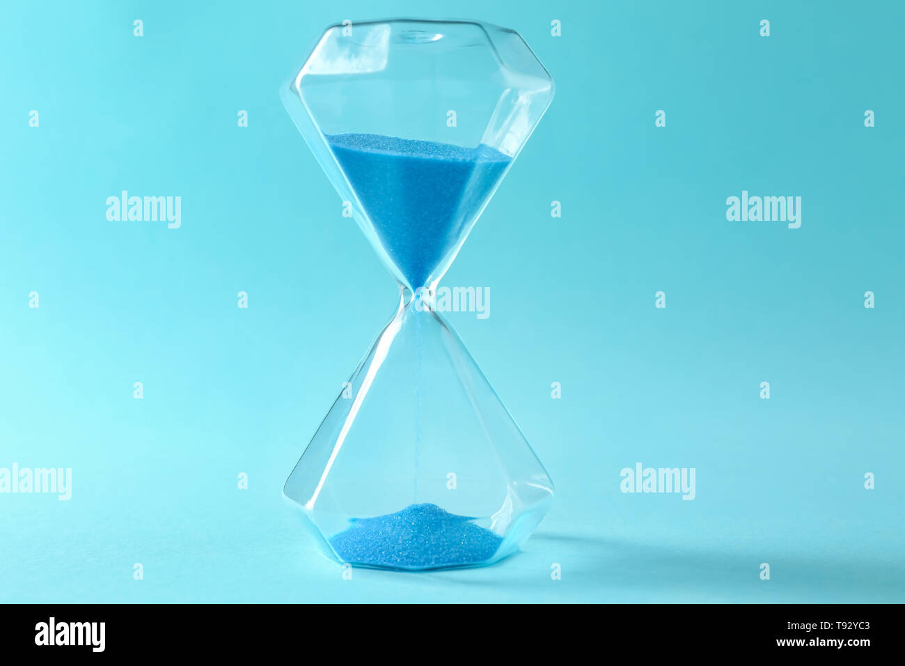 Hourglass on color background. Time management concept Stock Photo - Alamy