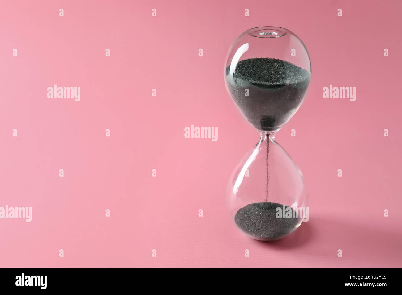 Hourglass on color background. Time management concept Stock Photo - Alamy