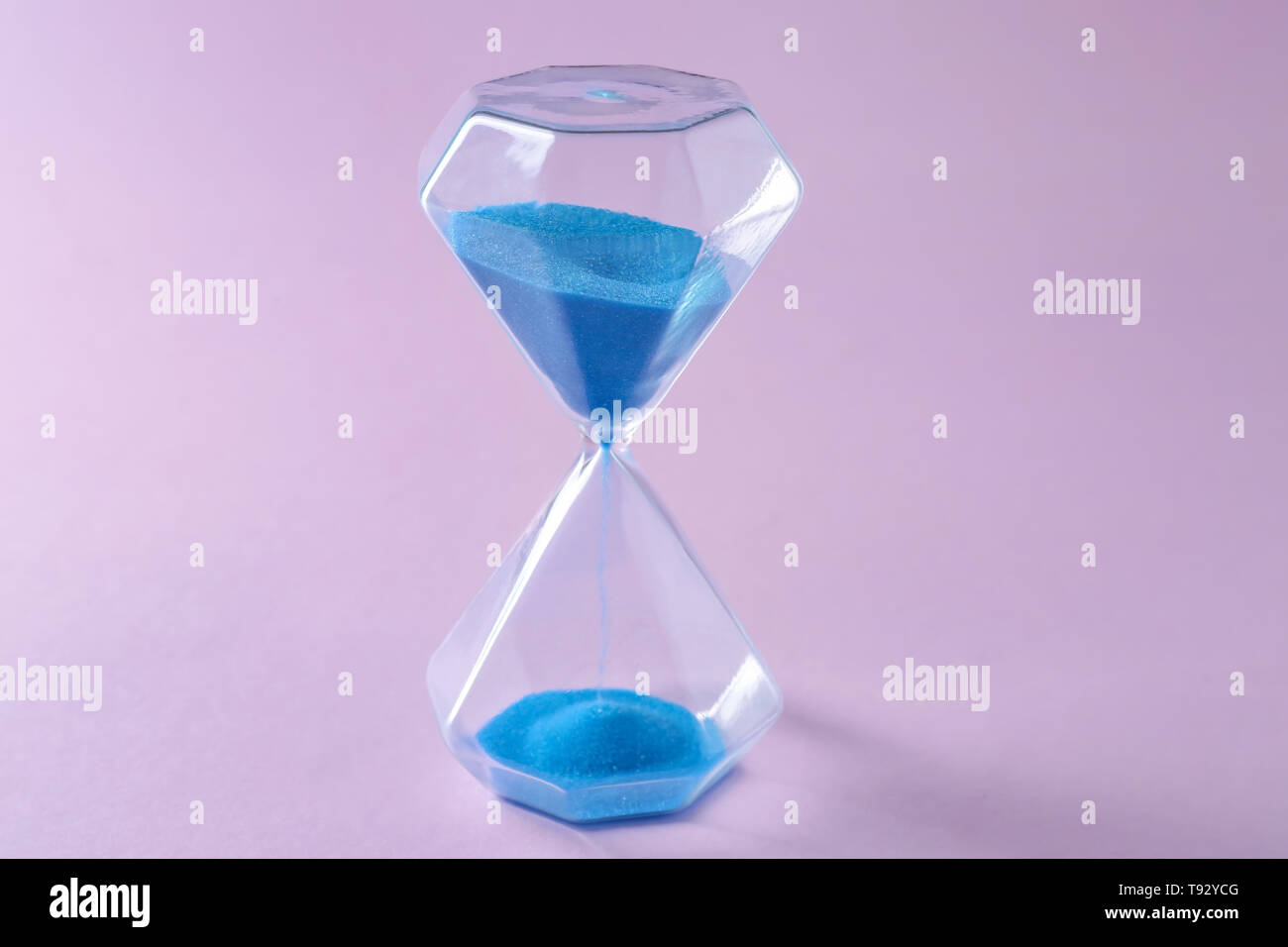 Hourglass on color background. Time management concept Stock Photo - Alamy