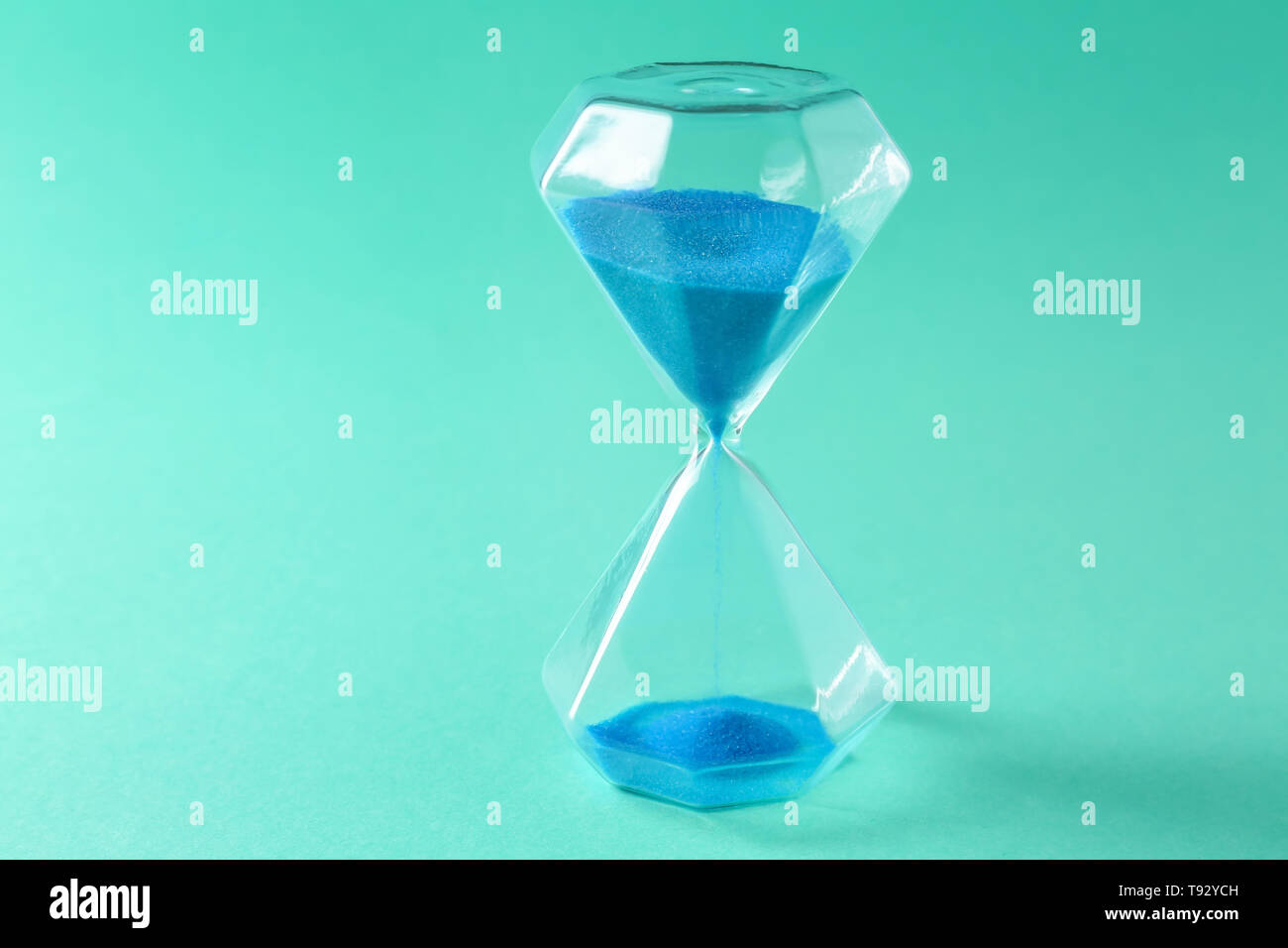 Hourglass on color background. Time management concept Stock Photo - Alamy
