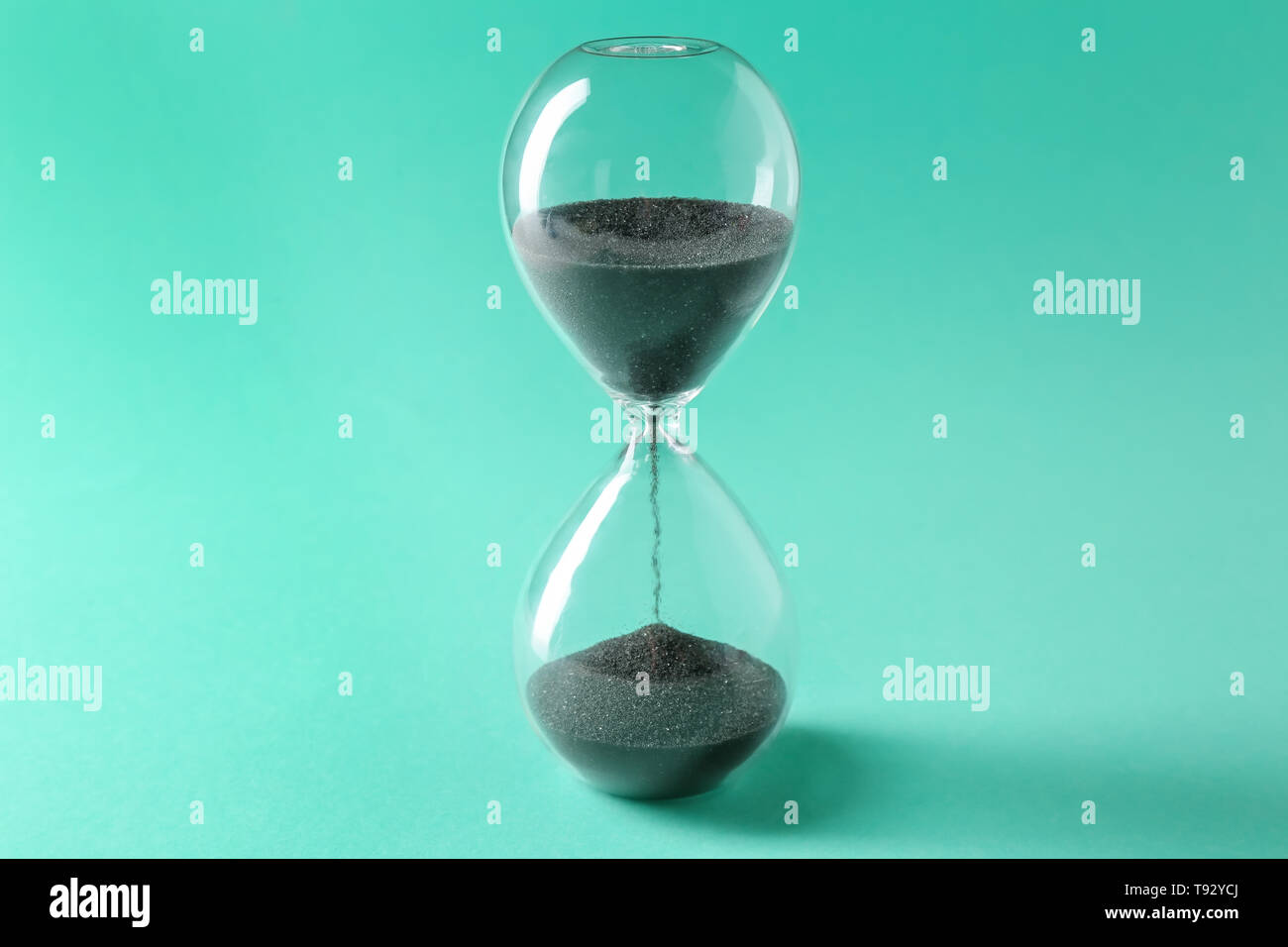 Hourglass on color background. Time management concept Stock Photo - Alamy