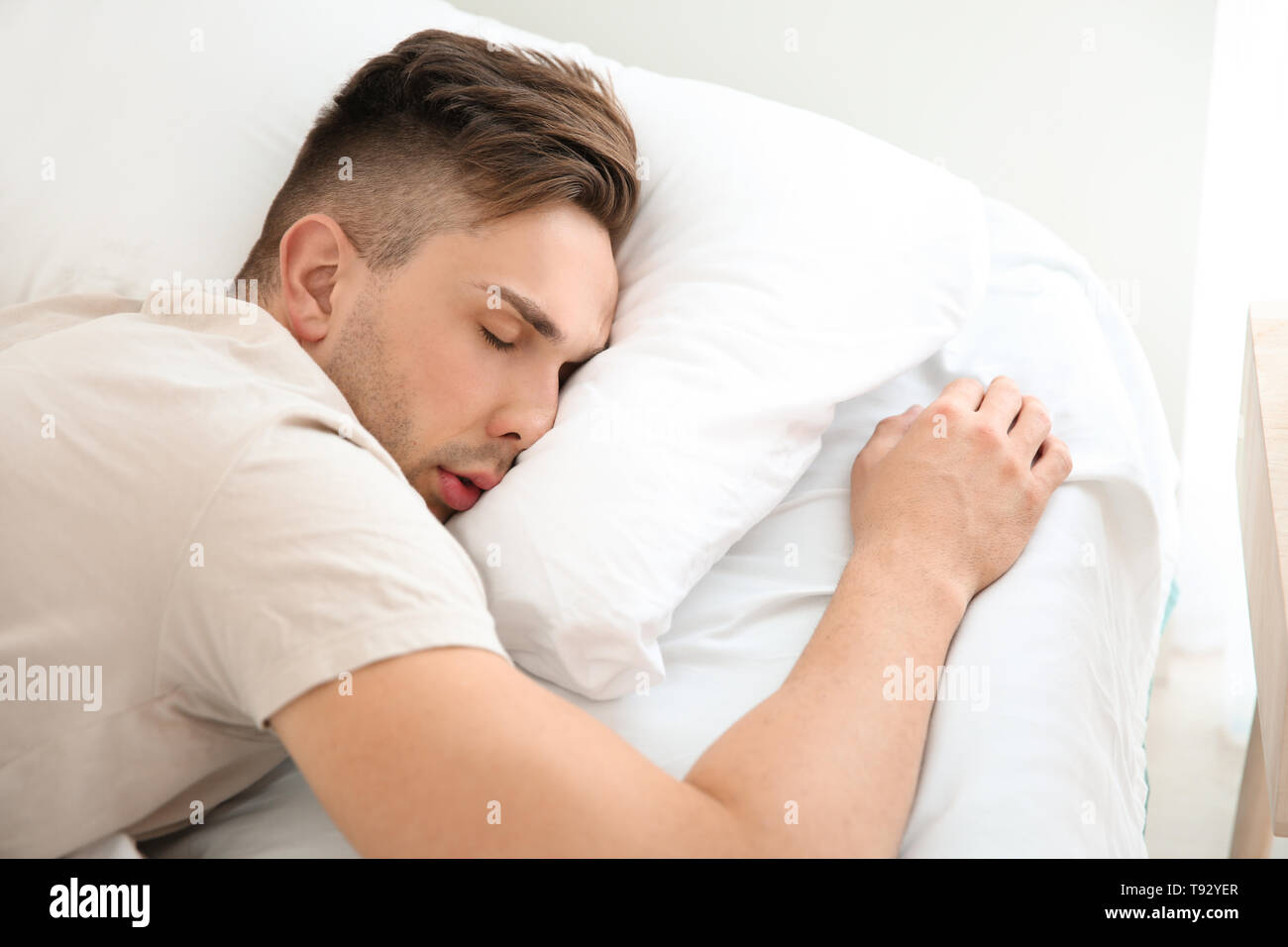 Handsome man sleeping in bed at home Stock Photo - Alamy