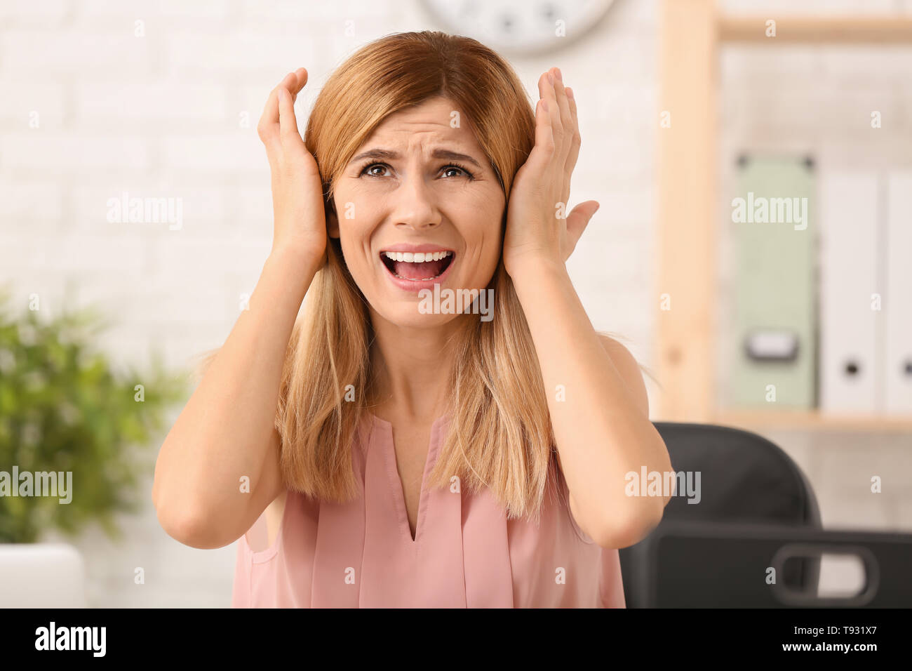 Woman having panic attack at workplace Stock Photo - Alamy