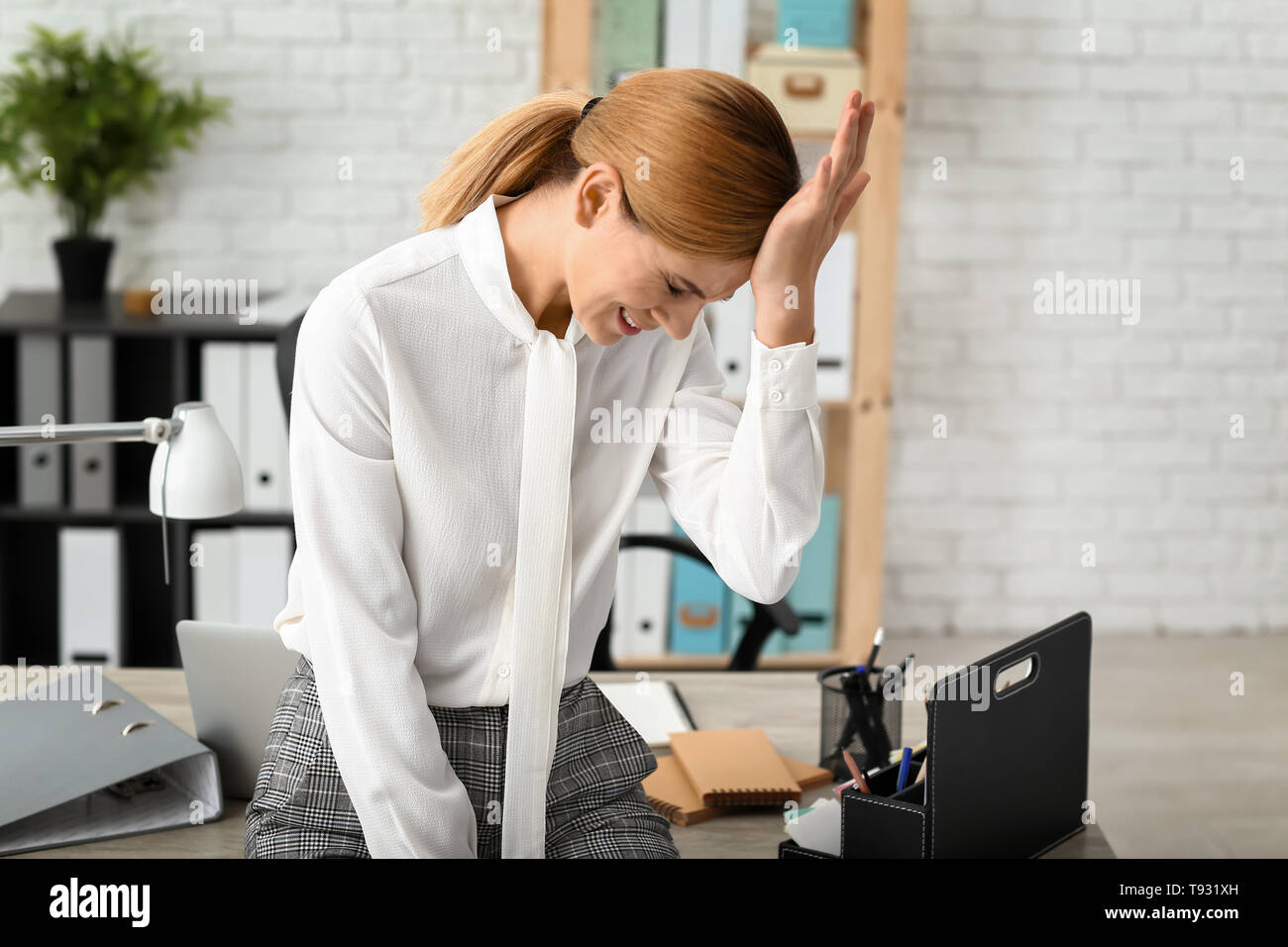 Woman having panic attack at workplace Stock Photo - Alamy