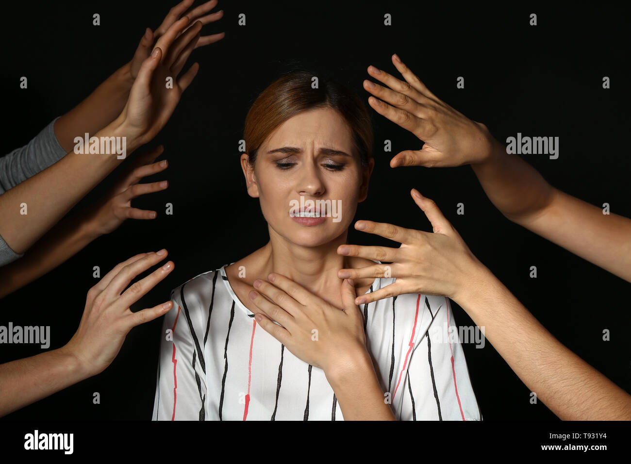 Many hands stretched to woman on dark background. Panic attack Stock ...